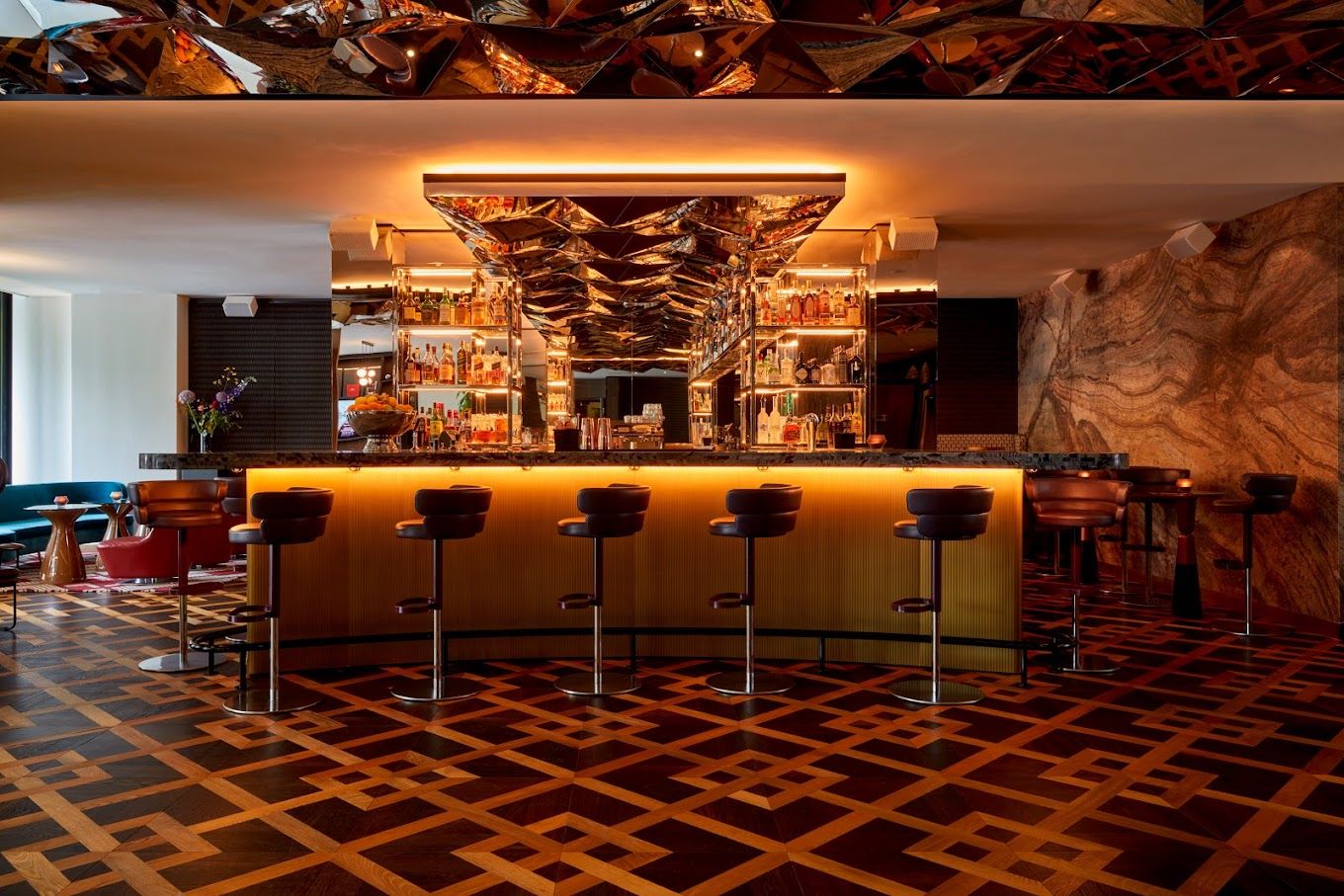 Opulent Cocktail Bar With a Reflective Geometric Ceiling for Upscale ...
