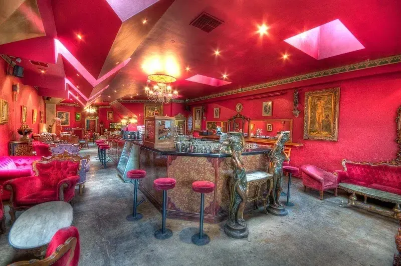1920s-Inspired Parisian Salon With Red Velvet Seating for Intimate ...